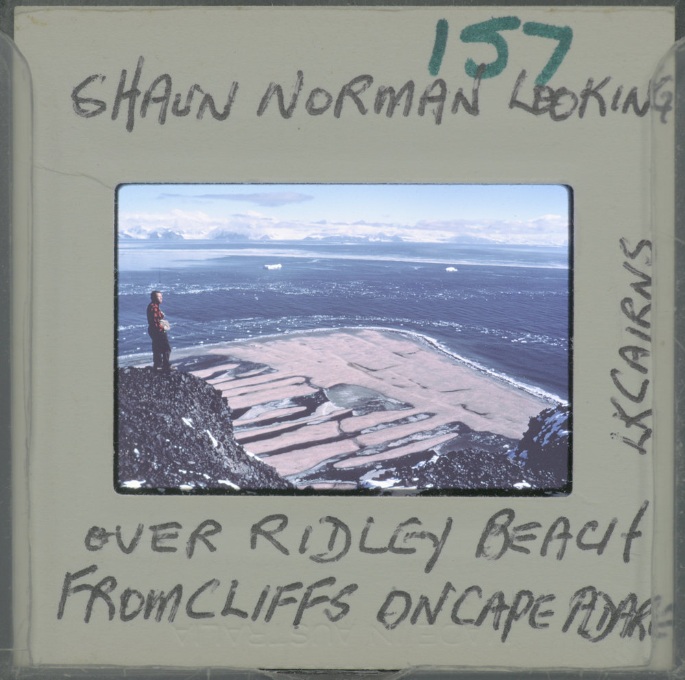 Shaun Norman looking over Ridley Beach from cliffs on Cape Adare ...